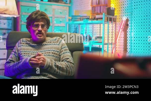 Caucasian afraid young man nerd in glasses and with mustache sitting in ...