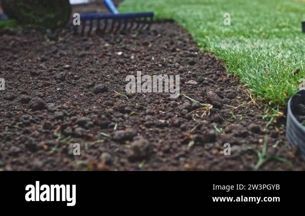 Gardener Grading Out Soil With A Rake. SLOW MOTION. Unrecognizable ...