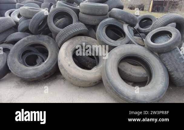 a mountain of old tires. dump of used wheels. Industrial landfill for the processing of waste ...