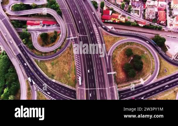 Aerial view of highway in city. Clip. Cars crossing interchange overpass. Highway interchange ...