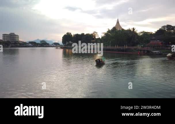 cinematic shot of boats carrying passenger across sarawak river in ...