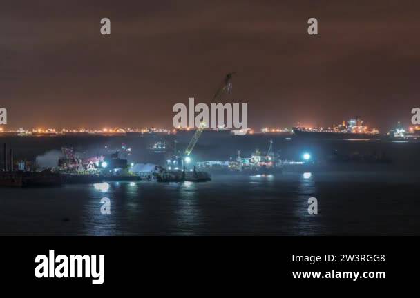 Singapore Marina Barrage with cargo ships waiting to enter one of the ...