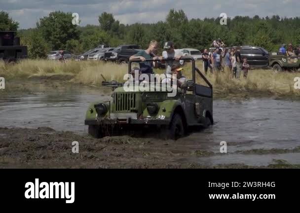Festival of off-road lovers. SUVs drive the swamp. Cars skid in the mud ...