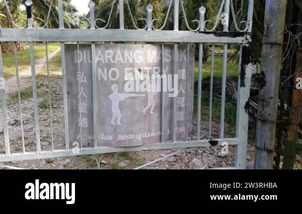 Signboard on the gate written in English, Malay and Mandarin language ...