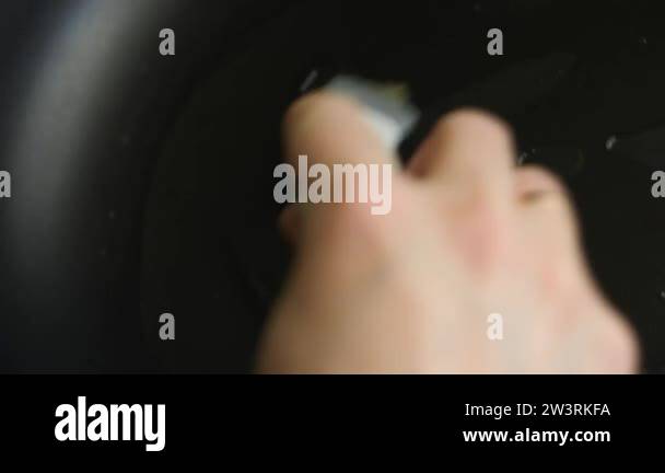 Macro view of greasing the frying pan with sunflower oil. Cooking a ...