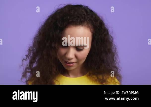 Woman with curly hairstyle showing yes sign, nods her head approvingly ...