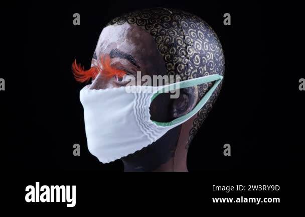 Black woman doll head in protective medical face mask rotation, New ...