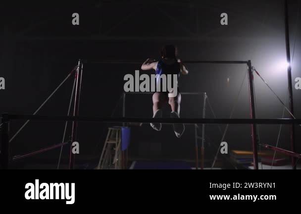 uneven bars performance of young gymnast girl in sports hall ...