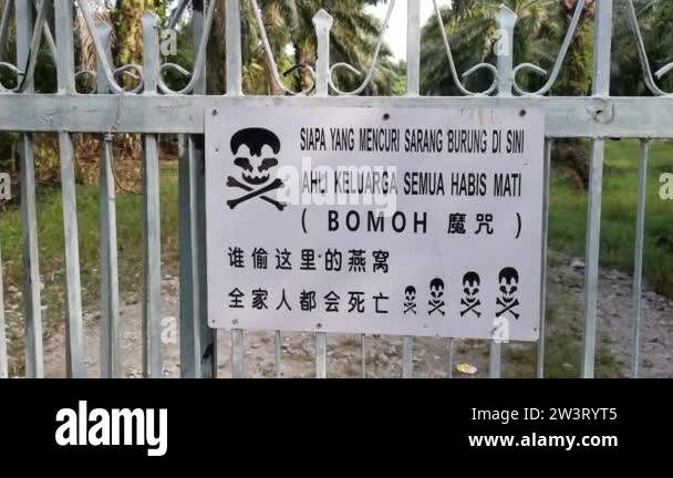 Signboard on the gate written in Malay and Mandarin language which says ...