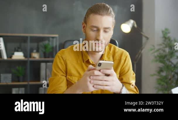 Close up of Caucasian young man holding smartphone in hands and ...