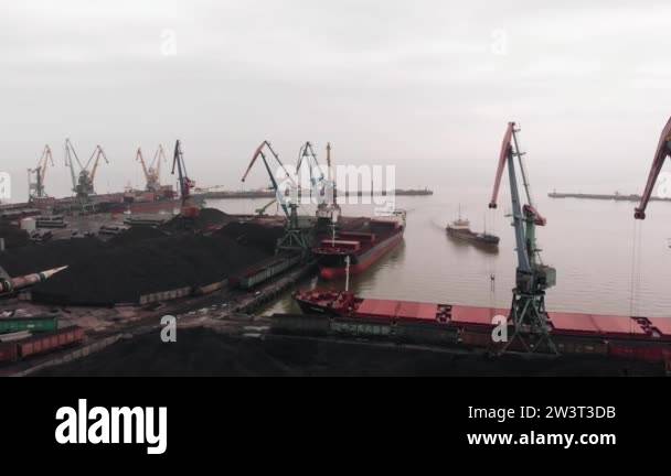 Shooting from drone of a sea cargo port with tower cranes and tankers ...