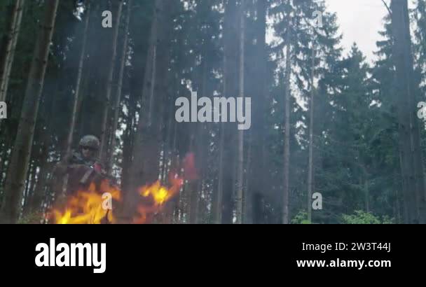 firefighter hero in action danger jumping over fire flame to rescue and ...