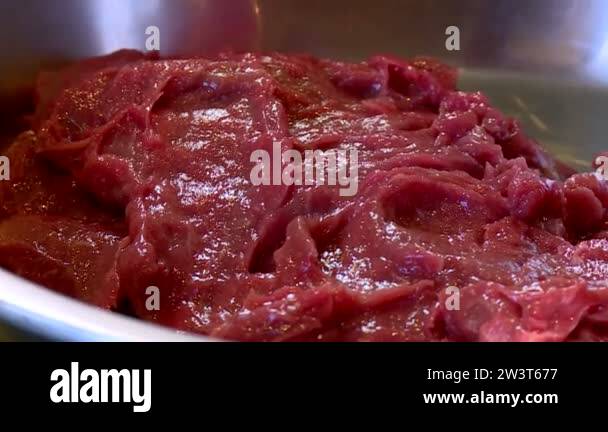 Cook preparing minced meat manually. Then put the filling in a pot of ...