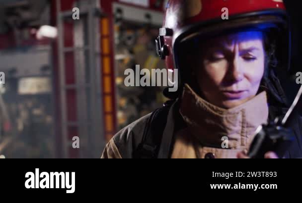 Portrait of upset scared on panic female fireman in helmet and gull ...
