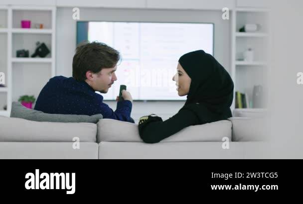 Traditional muslim family watching TV together on the sofa Stock Video ...