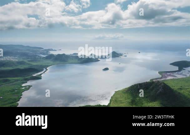 Drone captures the landscape with azure sea in the bay and a green ...