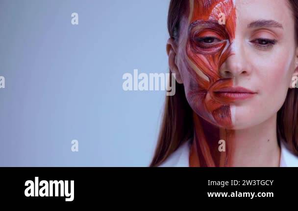 Young woman with half of face with muscles structure under skin. Model ...