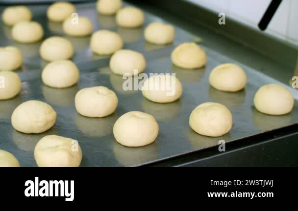 cooking. bakery products. close-up. blanks of raw yeast dough for buns ...