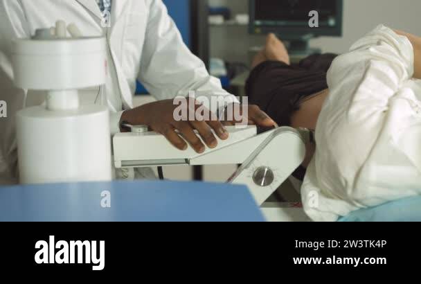 Extracorporeal shockwave therapy in urology. Cropped shot of belly of ...