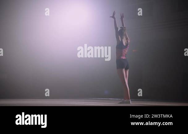 junior female gymnast at competition, teen girl is preparing to perform ...