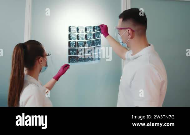 Computed tomography in the clinic. Two doctors examine a computed ...