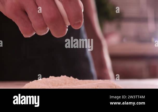 Falling egg into flour. Close up view of man hands breaking cracking ...
