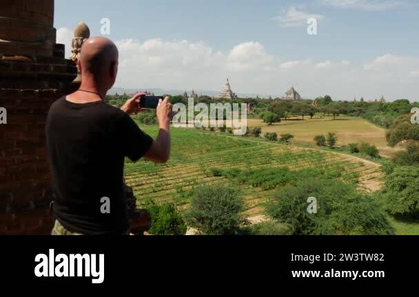 Man makes a photo with his mobile from the Pagodas in Bagan, Myanmar ...