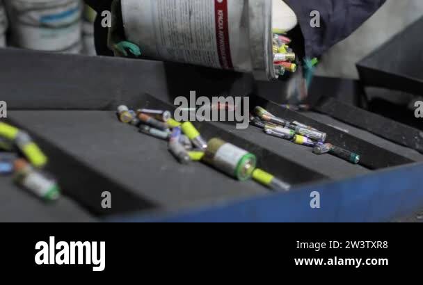 View of hands of person in uniform and gloves pouring out used ...