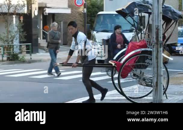 Traditional human drawn carriage in Tokyo with passenger Stock Video ...