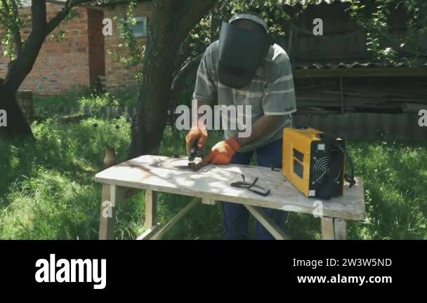 Man builder working with metal steel and iron using welding machine at ...