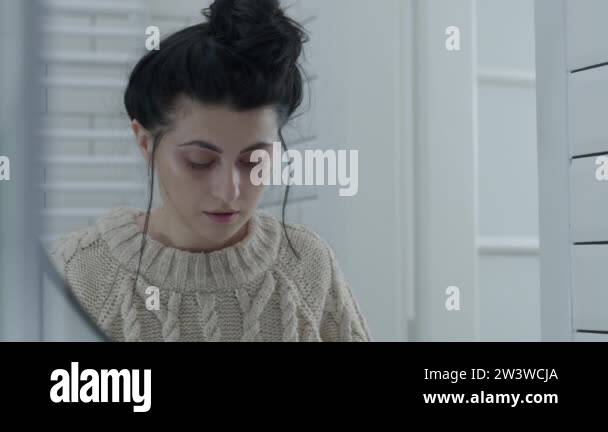 girl looks at his weary look in the mirror that appeared from the ...