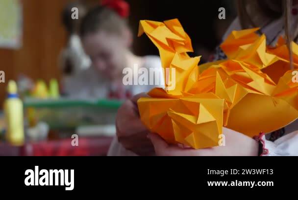 Girl In Vyshyvanka Makes Origami From Orange Paper Kids Make Origami ...