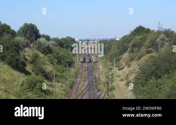 Locomotives with freight cars stand on a spare track waiting for a ...