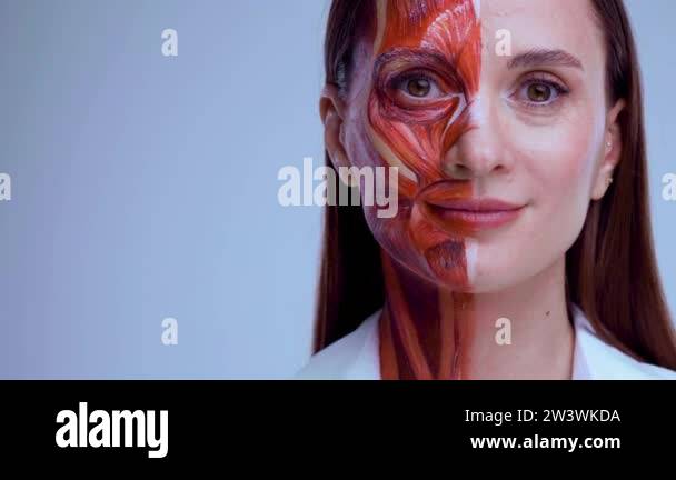 Young woman with half of face with muscles structure under skin. Model ...