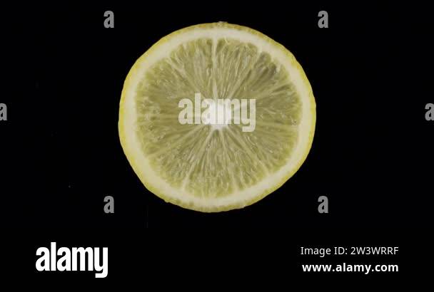 Rotation of a slice of lemon on a black background Stock Video Footage ...