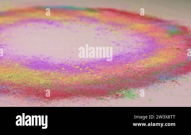 Sprinkle several colors of dust on the white paper that is spinning ...