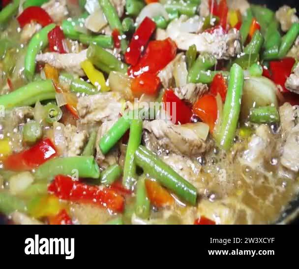 Sprinkle sesame seeds over vegetables stewed with meat in a pan ...