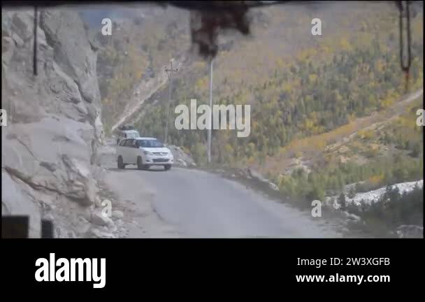 Car on the high altitude mountain road overtaking in hills tricky turns ...