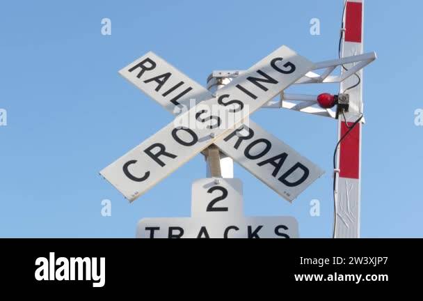 Level crossing warning signal in USA. Crossbuck notice and red traffic ...
