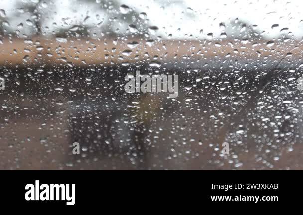 bokeh rain drops running down a window with morning sunlight ,Rainy Day Stock Video Footage - Alamy