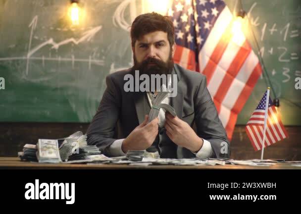 Serious bearded man holding dollar bills. Portrait of a satisfied ...