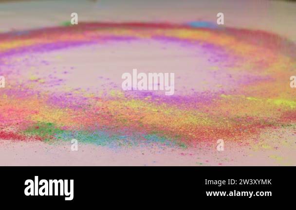 Sprinkle several colors of dust on the white paper that is spinning ...