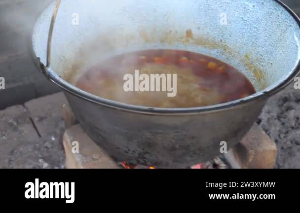Circular view of a caudron with bubbling homemade stew.Cooking Goulash ...