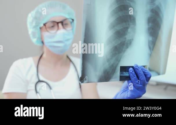 female doctor therapist examines the fluorography. woman pulmonologist ...
