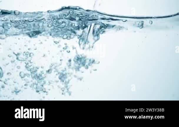 Brilliant stream of water in slow motion falls on smooth clean surface ...