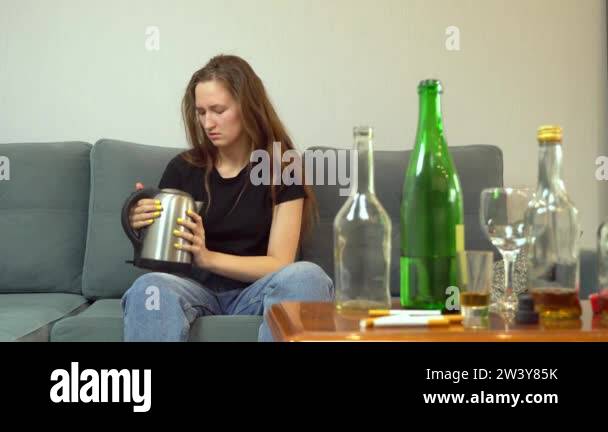 drunk woman after violent drinking session drinks water from spout of teapot Stock Video Footage ...