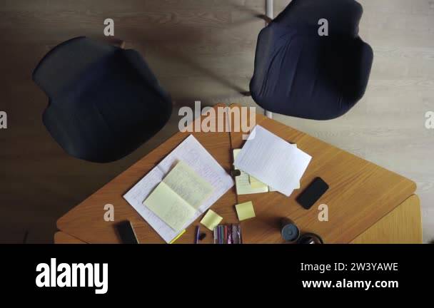 Two unrecognizable females coming and sit on chairs, starting hands ...