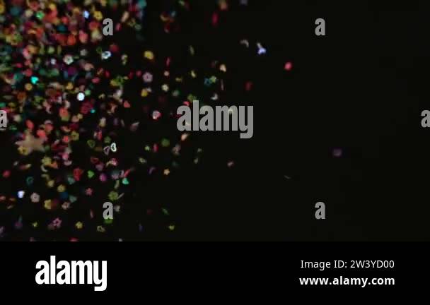 Close up Confetti explosion on black background. Slow Motion confetti falling video. Multi color ...