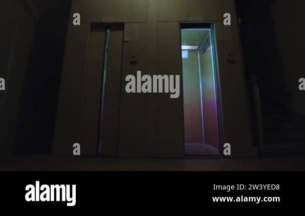 Elevator doors open and close on an empty floor with flashing disco ...