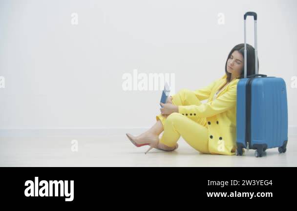 Tired business female lying down on suitcase and sleeping in an airport lounge Stock Video ...